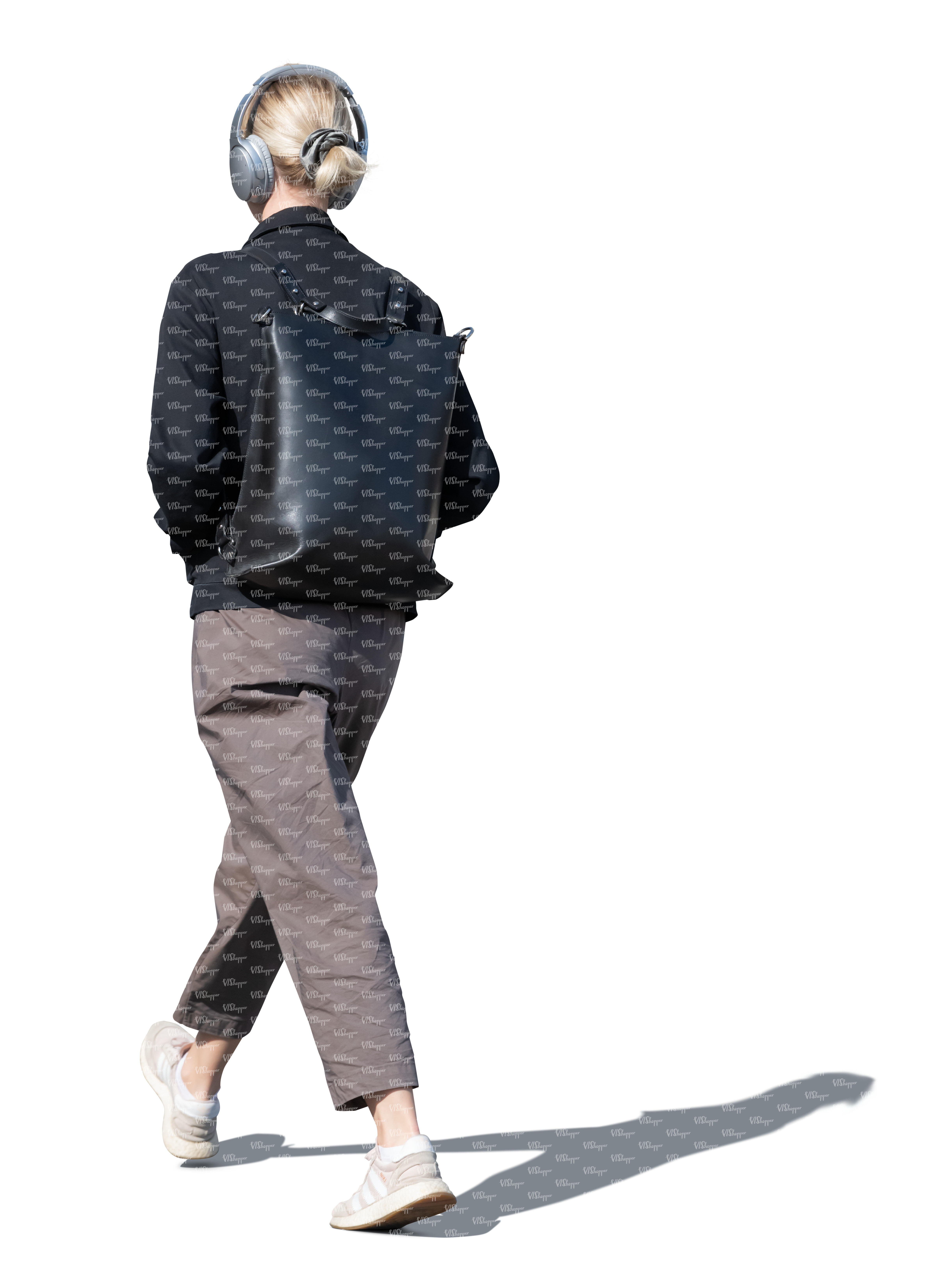 cut out woman with headphones walking on the street - VIShopper
